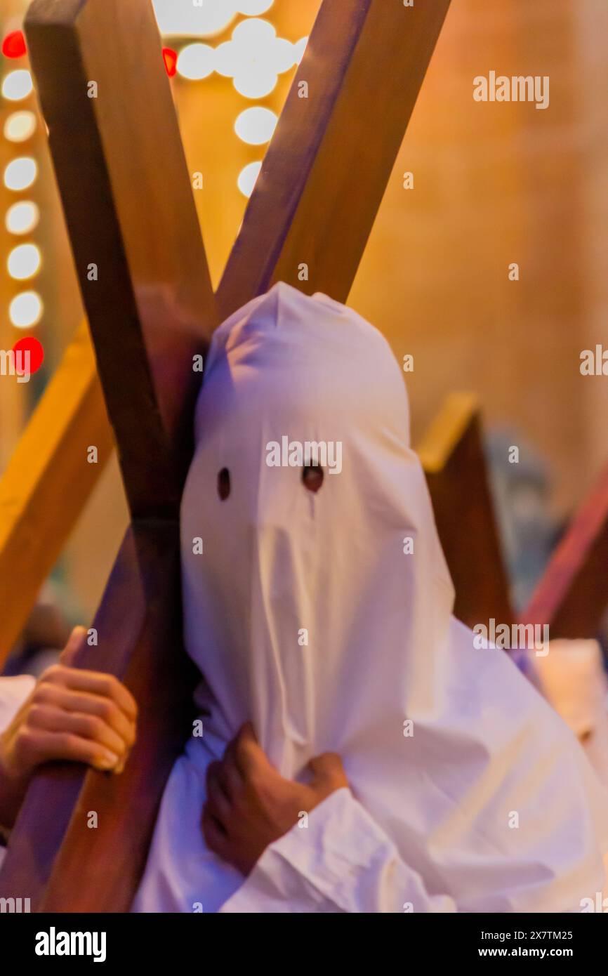 an unrecognizable person with a musk at the Good Friday procession 2024 ...