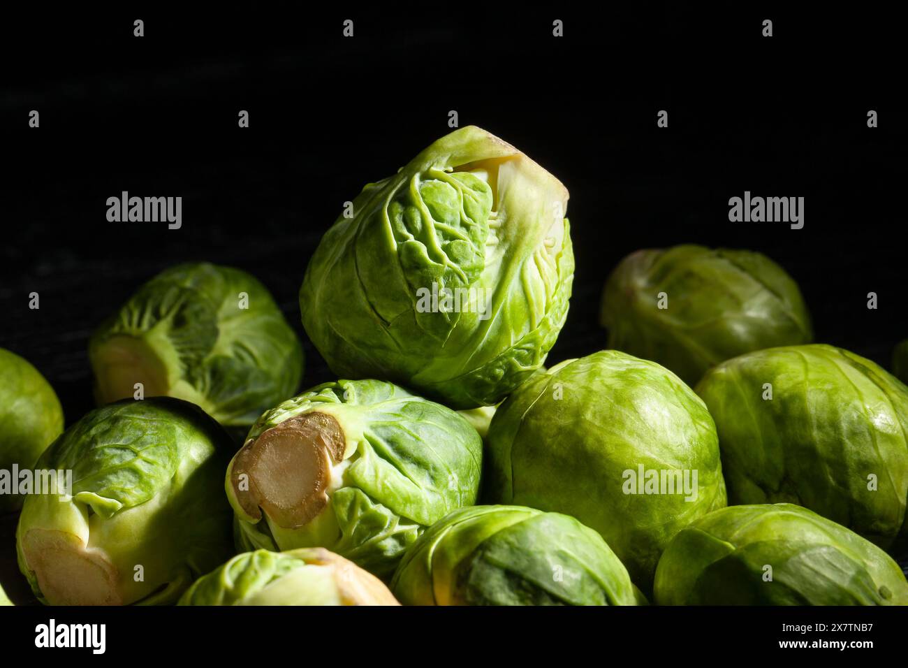 brussels sprouts on black background Stock Photo - Alamy