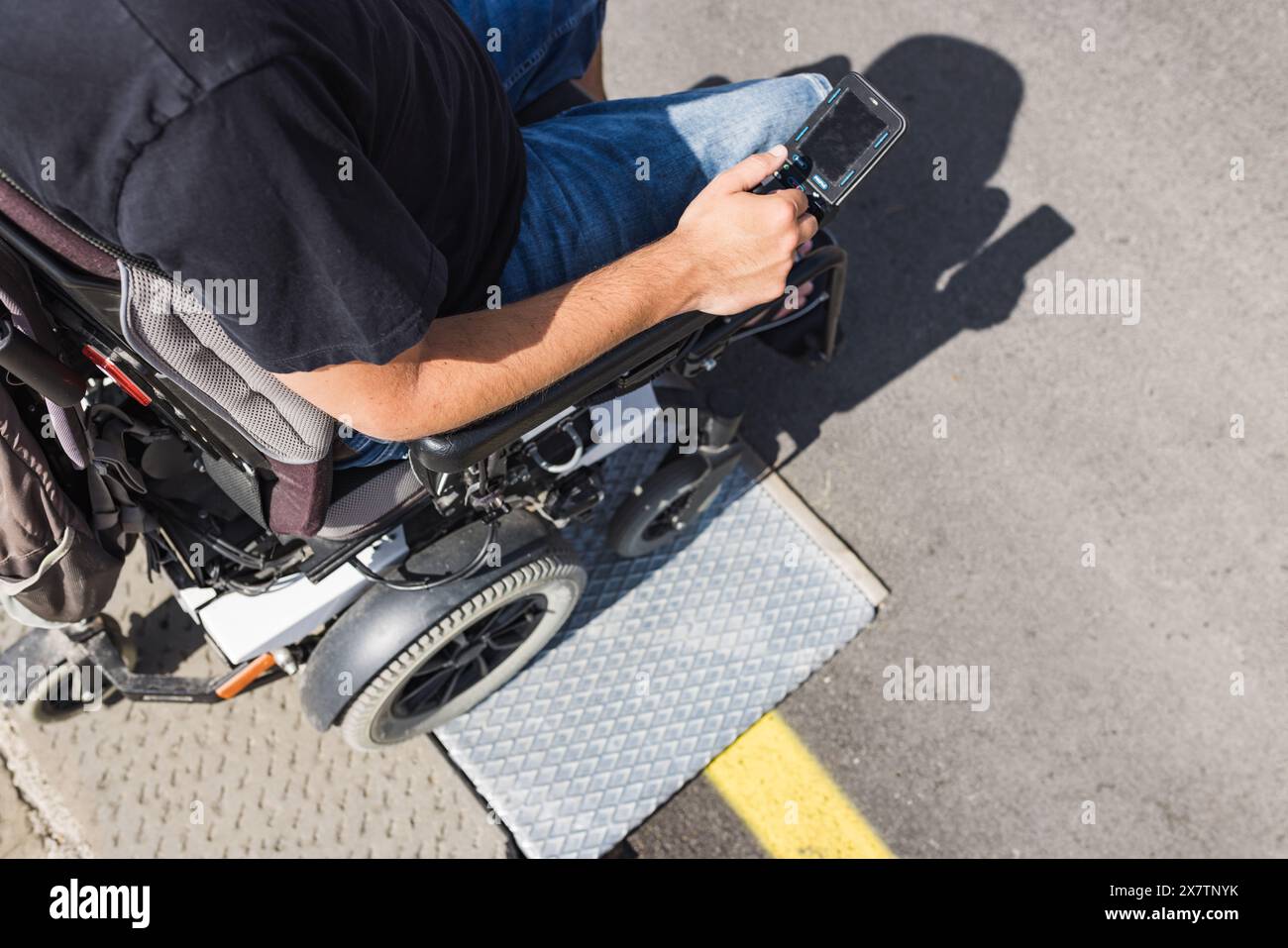 Male tourist on wheelchair crossing over the threshold ramp on the ...