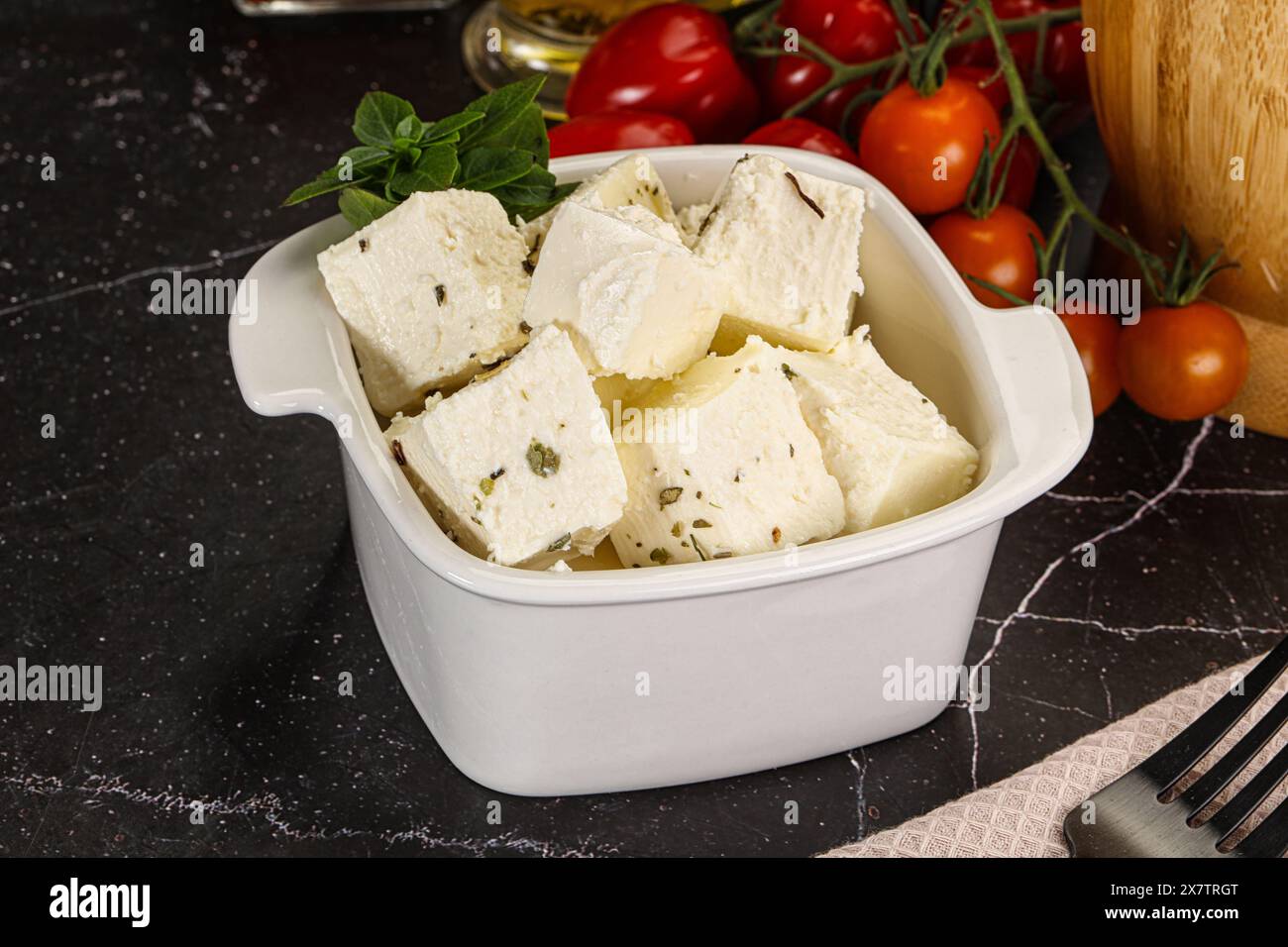 Greek traditional Feta cheese cubes with herbs and spices Stock Photo ...