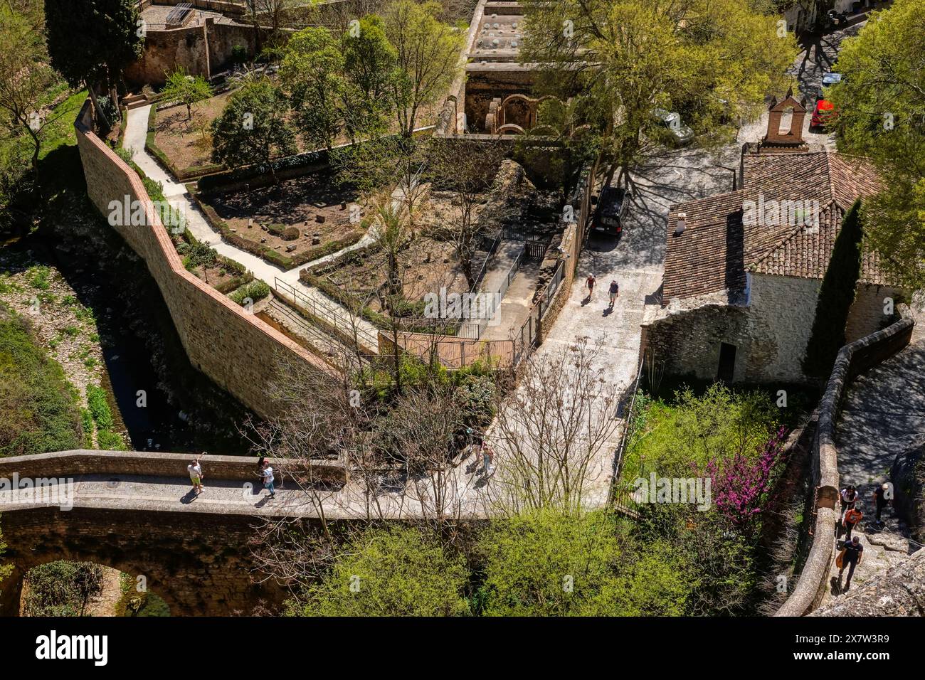 Tourists walk across the ancient Arab Bridge above the Roman Baths ...