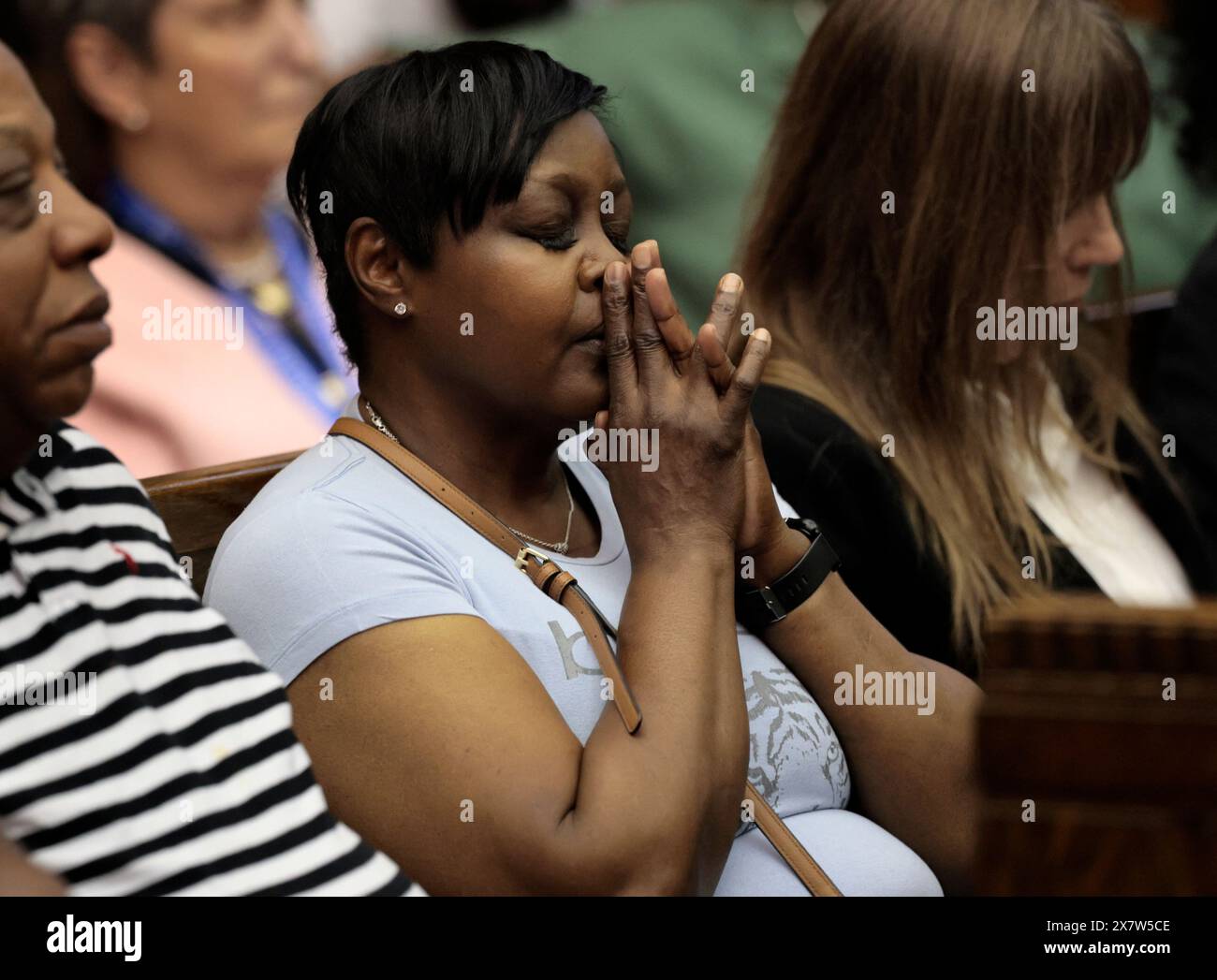 Laura Wilson listens in the gallery as her husband Eugene Wilson ...