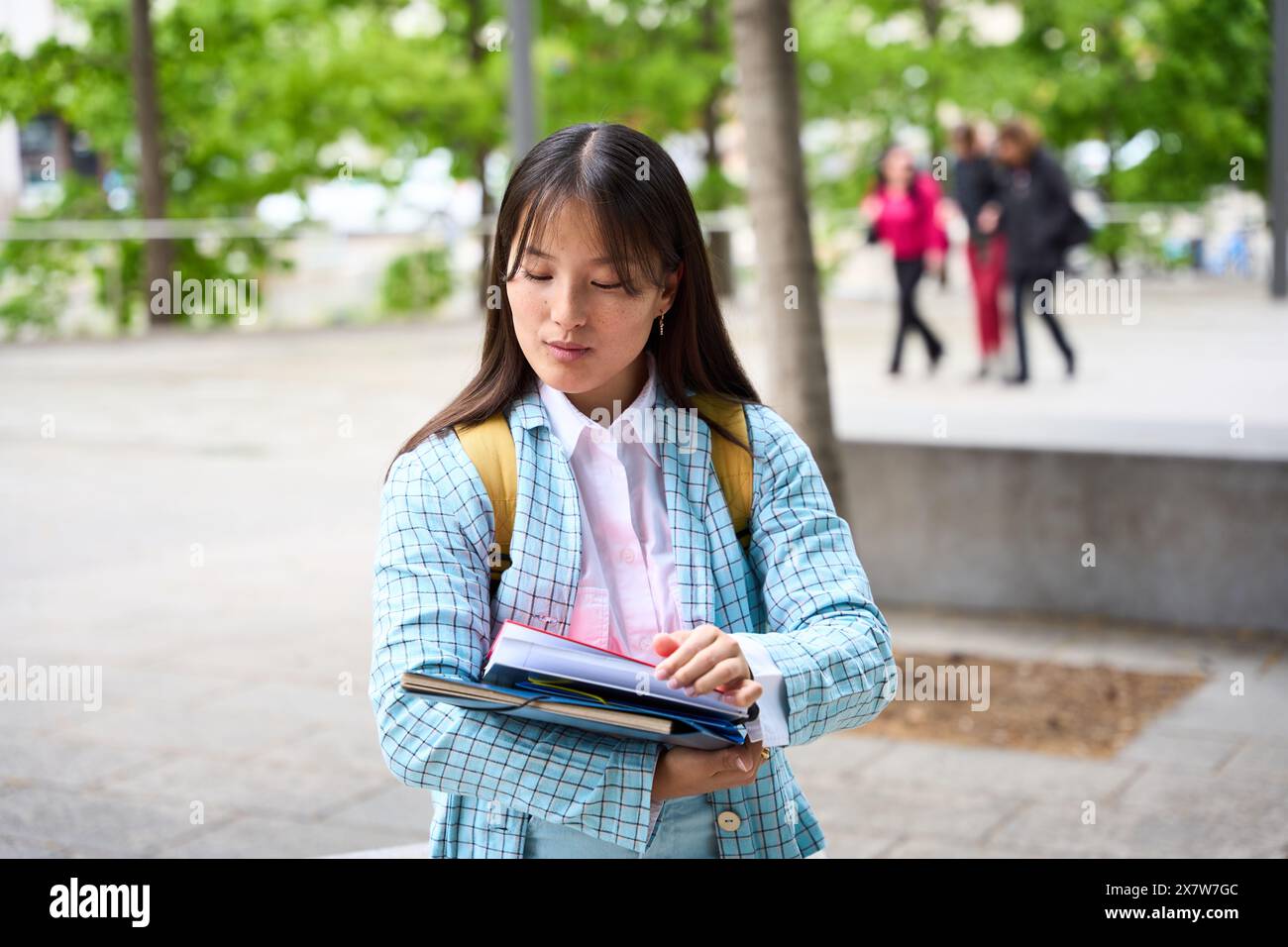 chinese student wearing a blue jacket at university Stock Photo - Alamy
