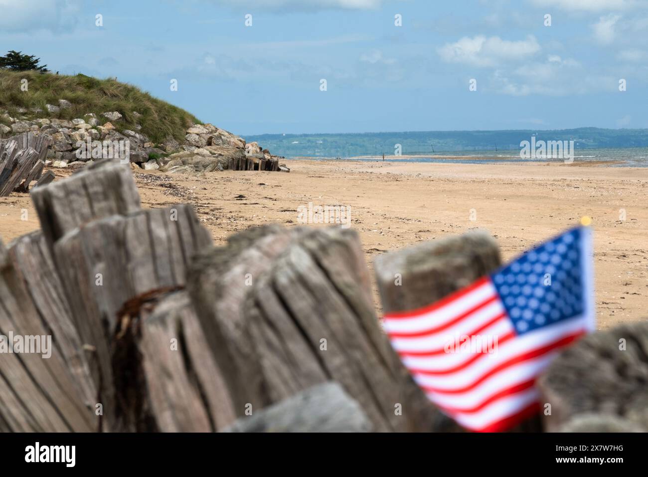 Utah Beach Normandy with USA flag selective focus on beach and ocean ...