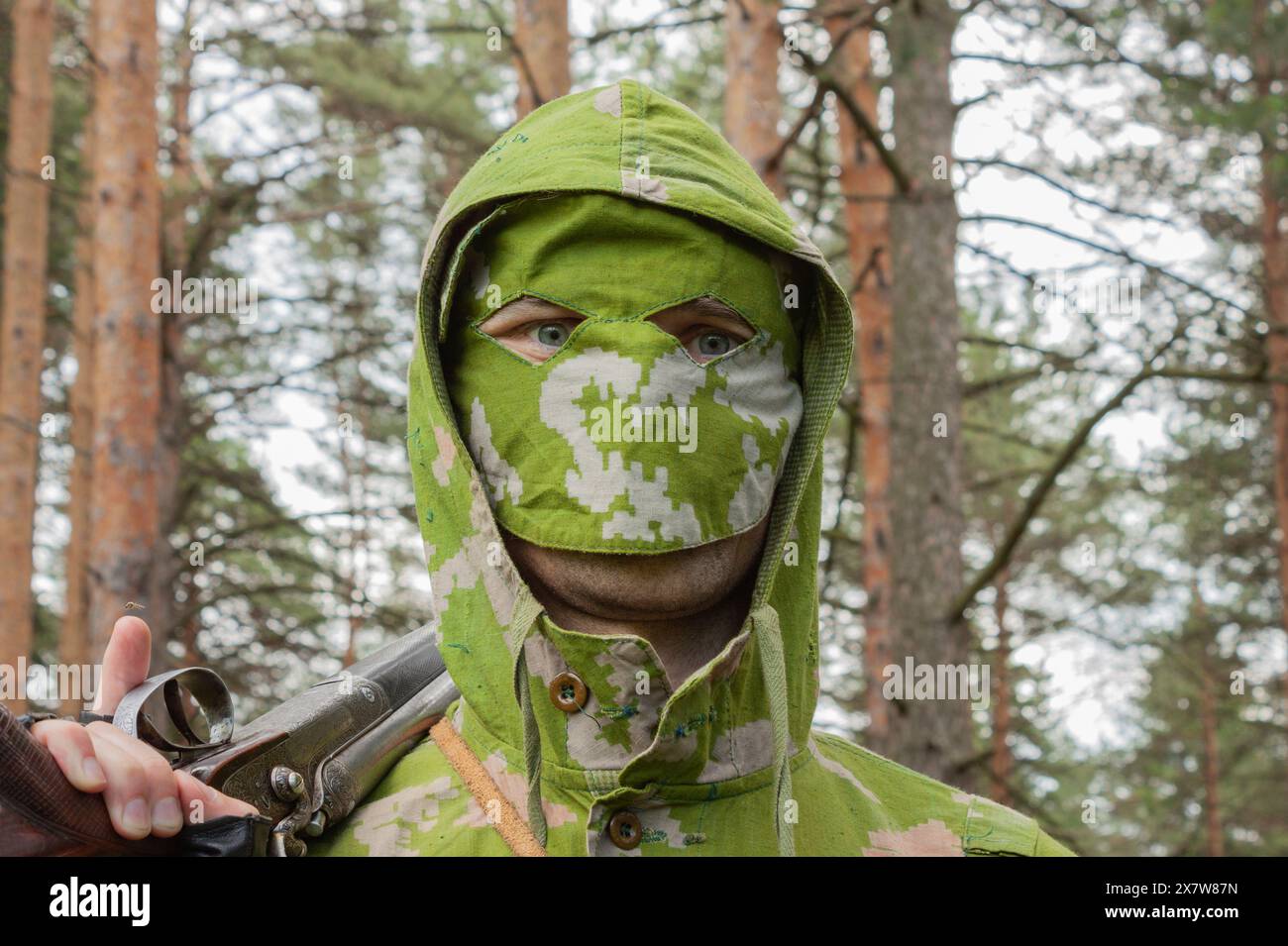 Gun on his shoulder and a man’s gaze through a camouflage mask Stock ...