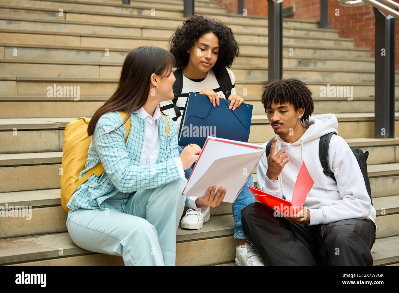 Diverse young students book outdoors hi-res stock photography and ...