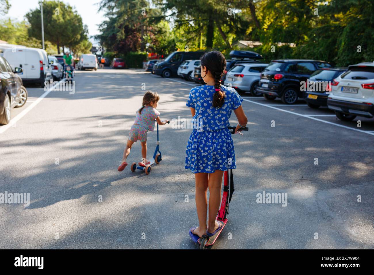Two girls riding scooter on hi-res stock photography and images - Alamy