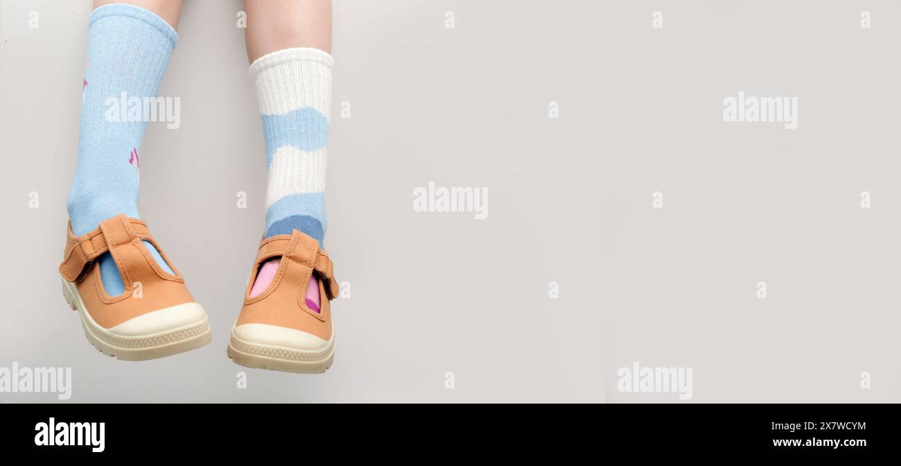 Kid wears different pair of socks. Child foots in mismatched socks ...
