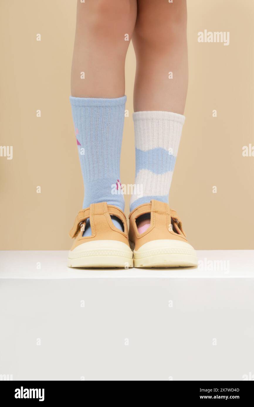 Kid wears different pair of socks. Child foots in mismatched socks ...
