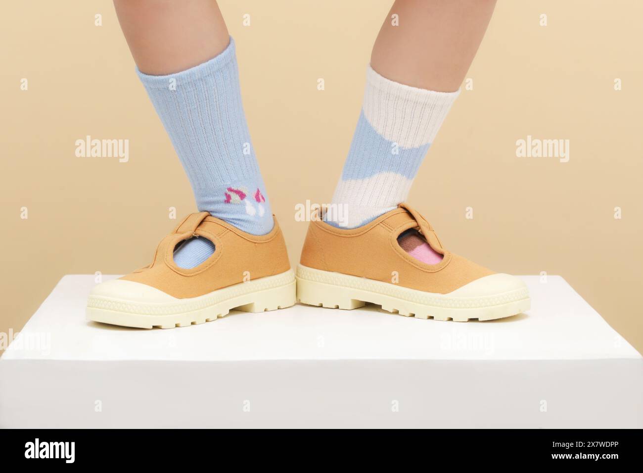 Kid wears different pair of socks. Child foots in mismatched socks ...