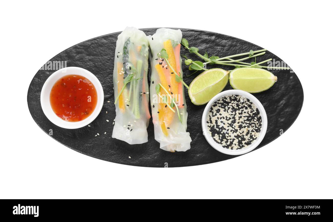 Tasty spring rolls, sauce, lime, sesame seeds and microgreens isolated ...