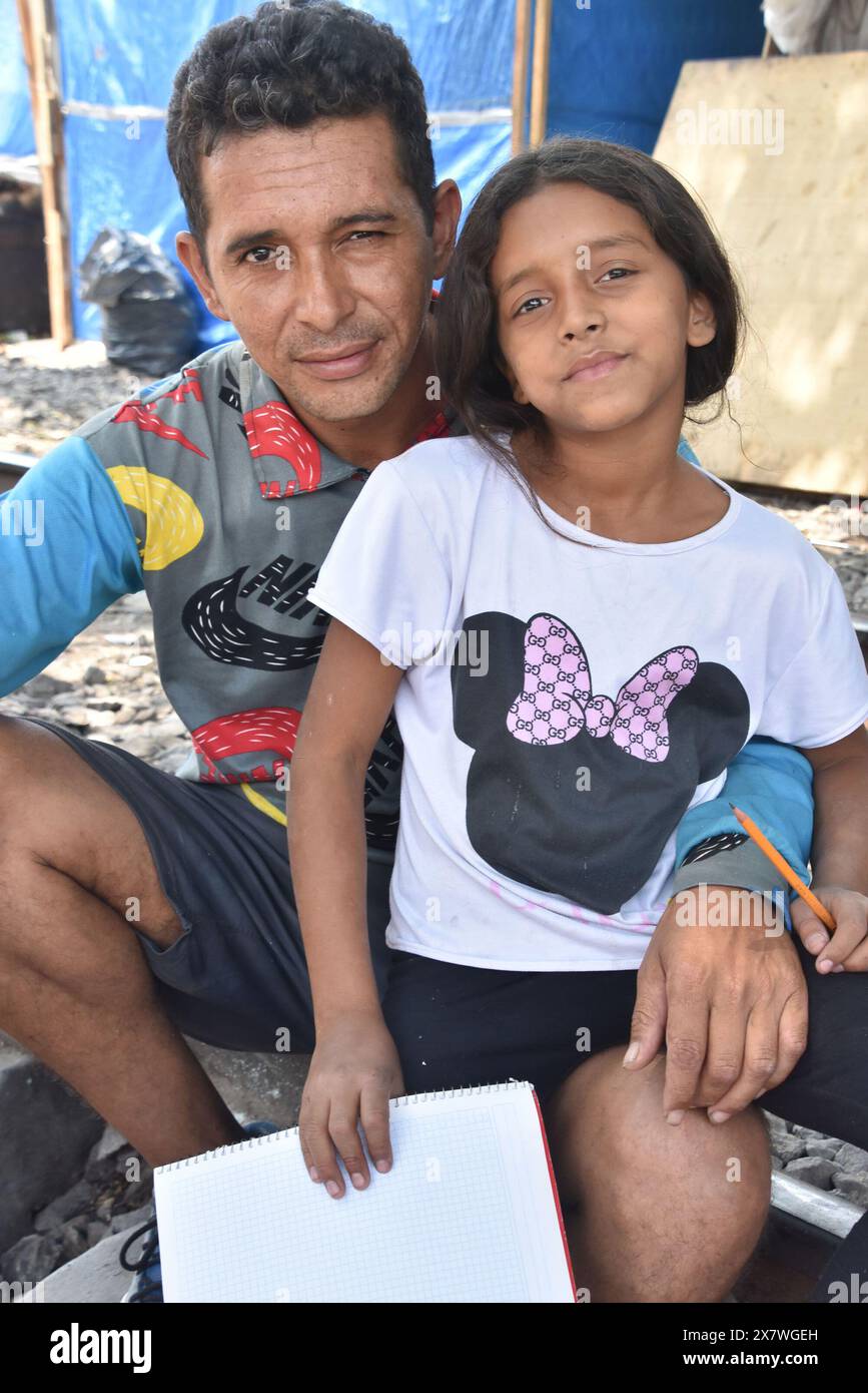 A Venezuelan father poses with his daughter in a migrant encampment in the Misterios ...