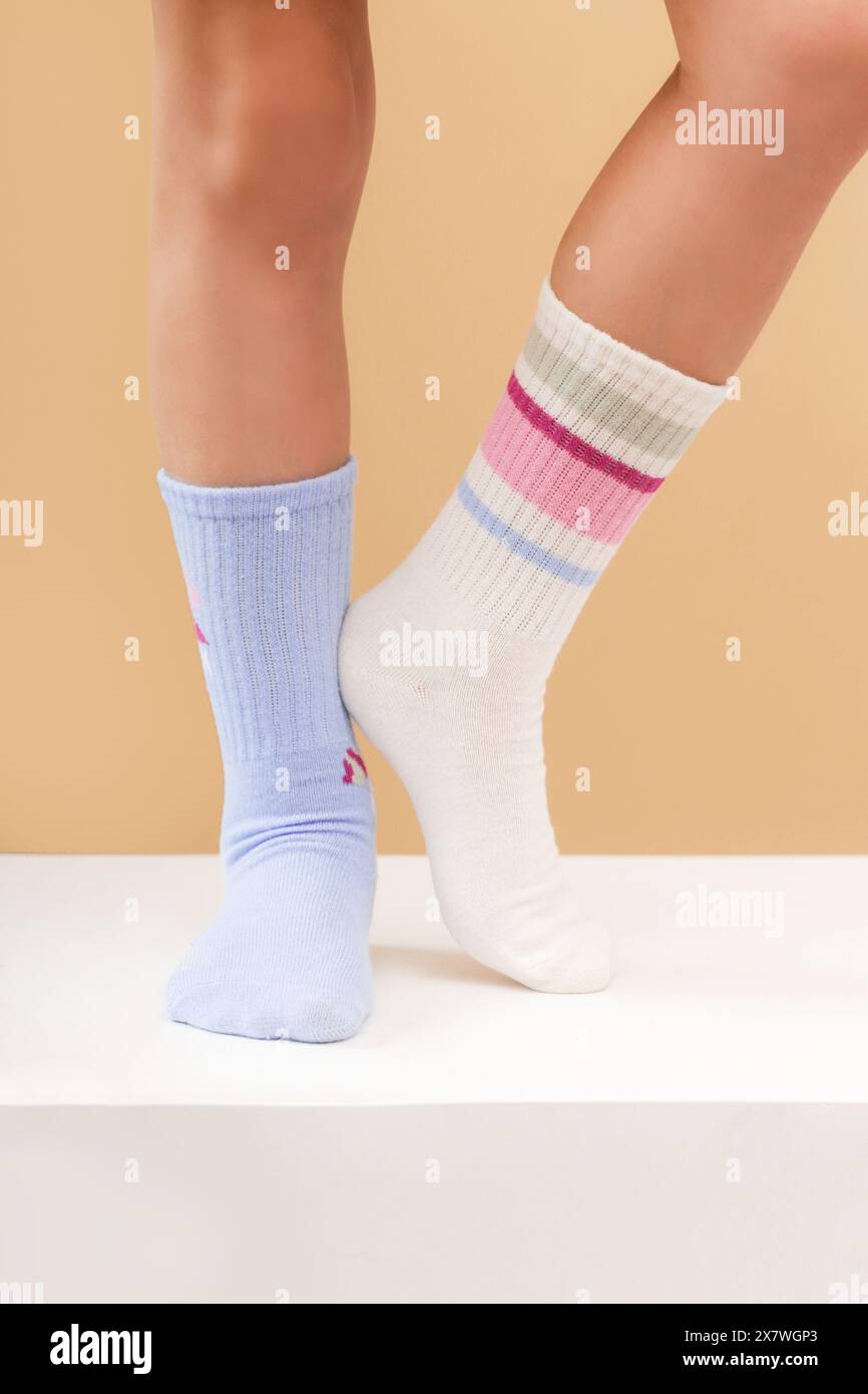 Kid wears different pair of socks. Child foots in mismatched socks ...