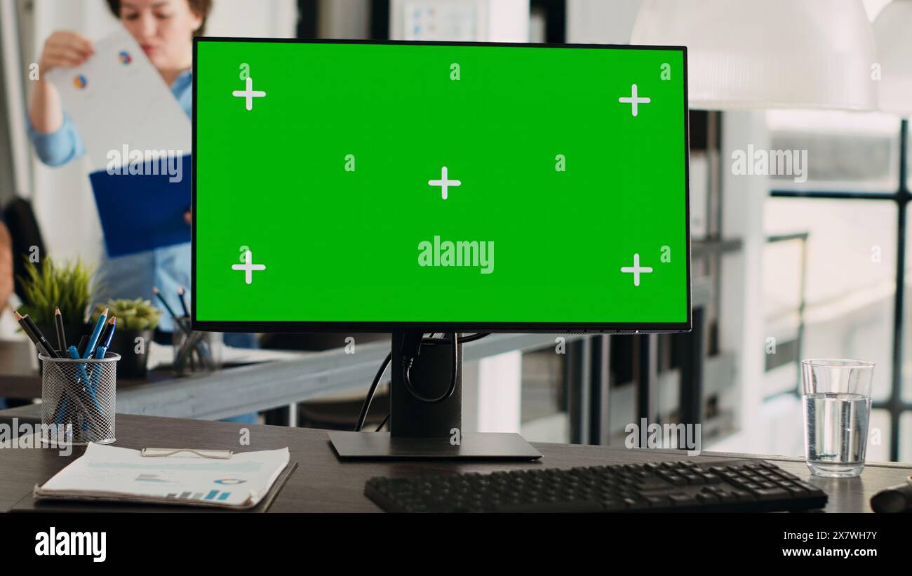 Greenscreen on computer desktop at empty workstation. PC with isolated ...