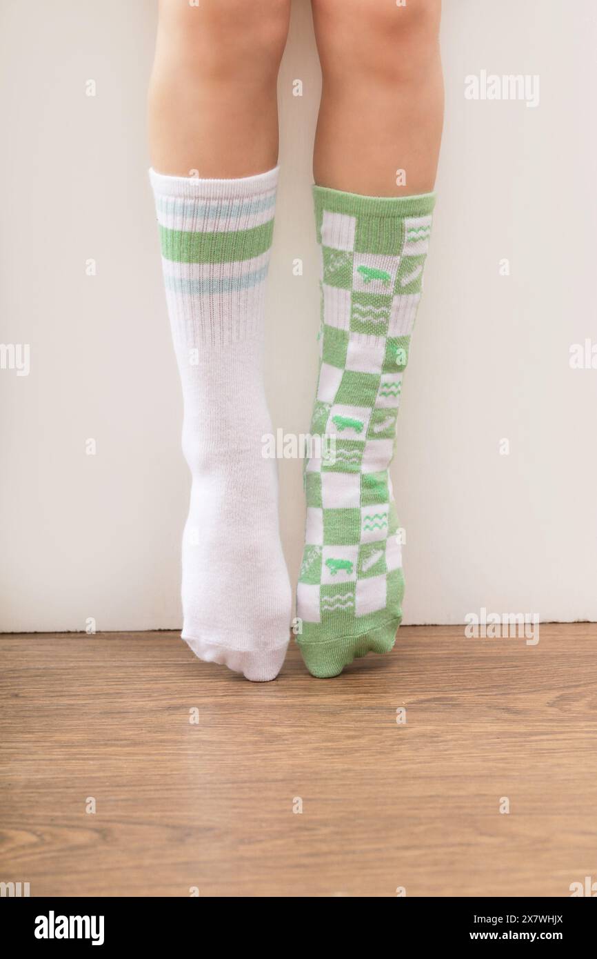 Kid wears different pair of socks. Child foots in mismatched socks ...