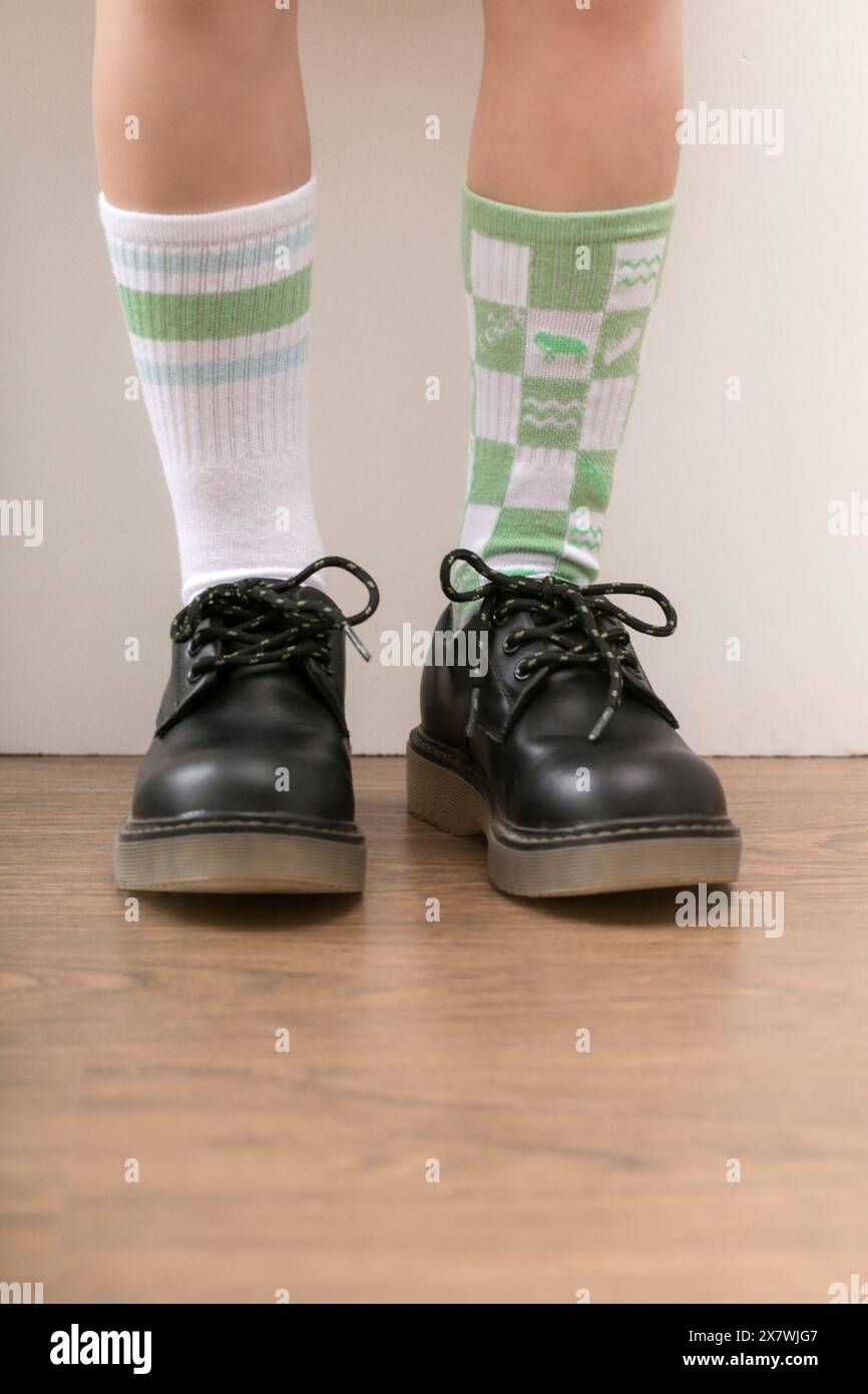 Kid wears different pair of socks. Child foots in mismatched socks ...