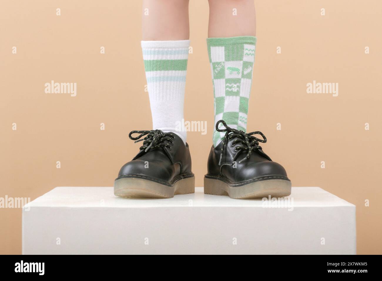 Kid wears different pair of socks. Child foots in mismatched socks ...