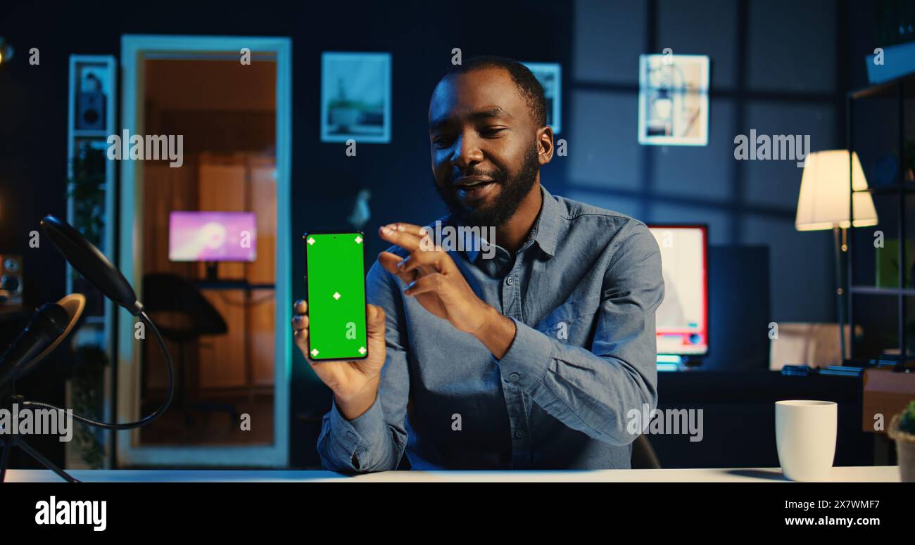 Content creator holding green screen product, being sponsored by tech ...