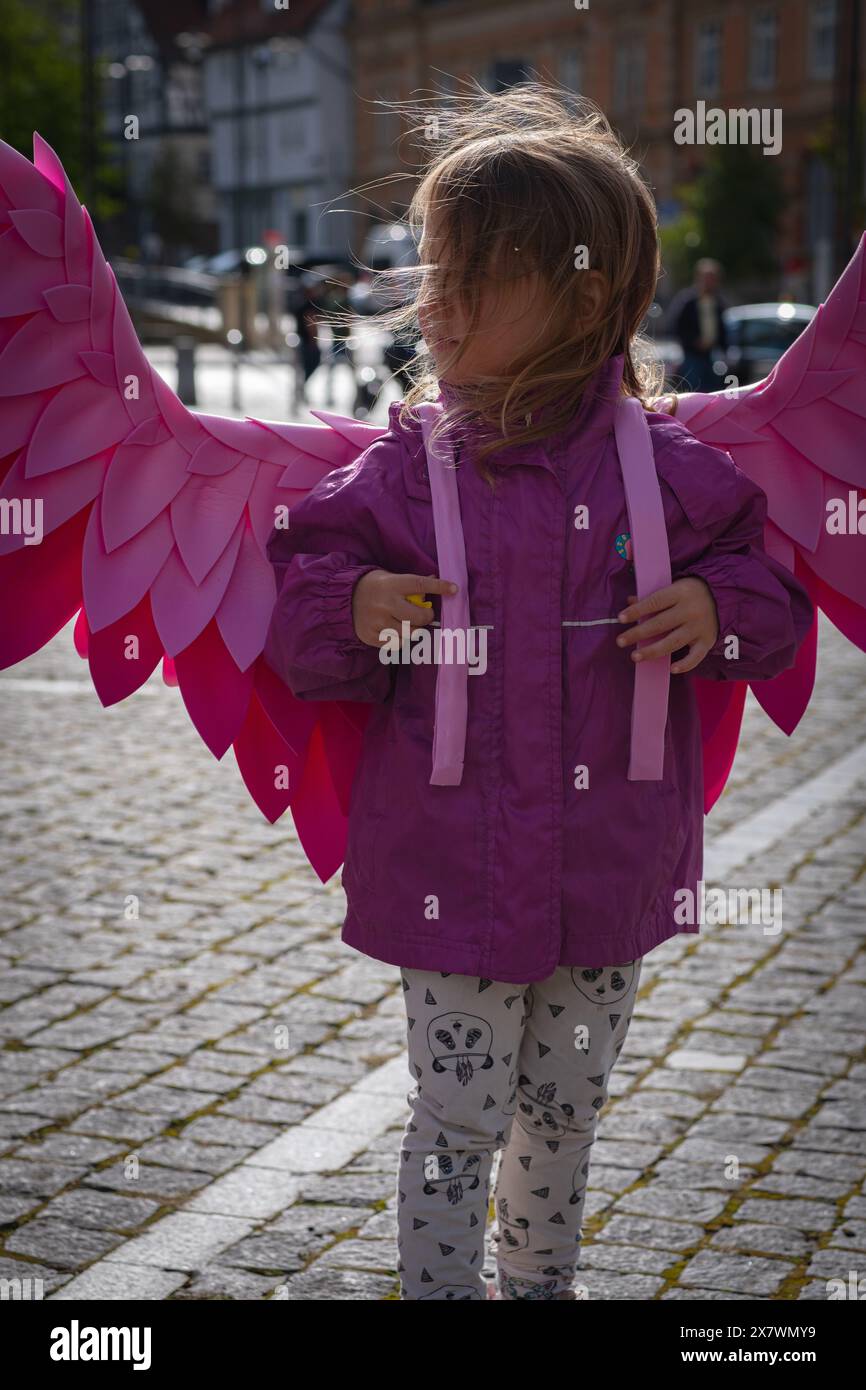 Beautiful young girl wearing pink angel wings. Little cute girl in pink ...