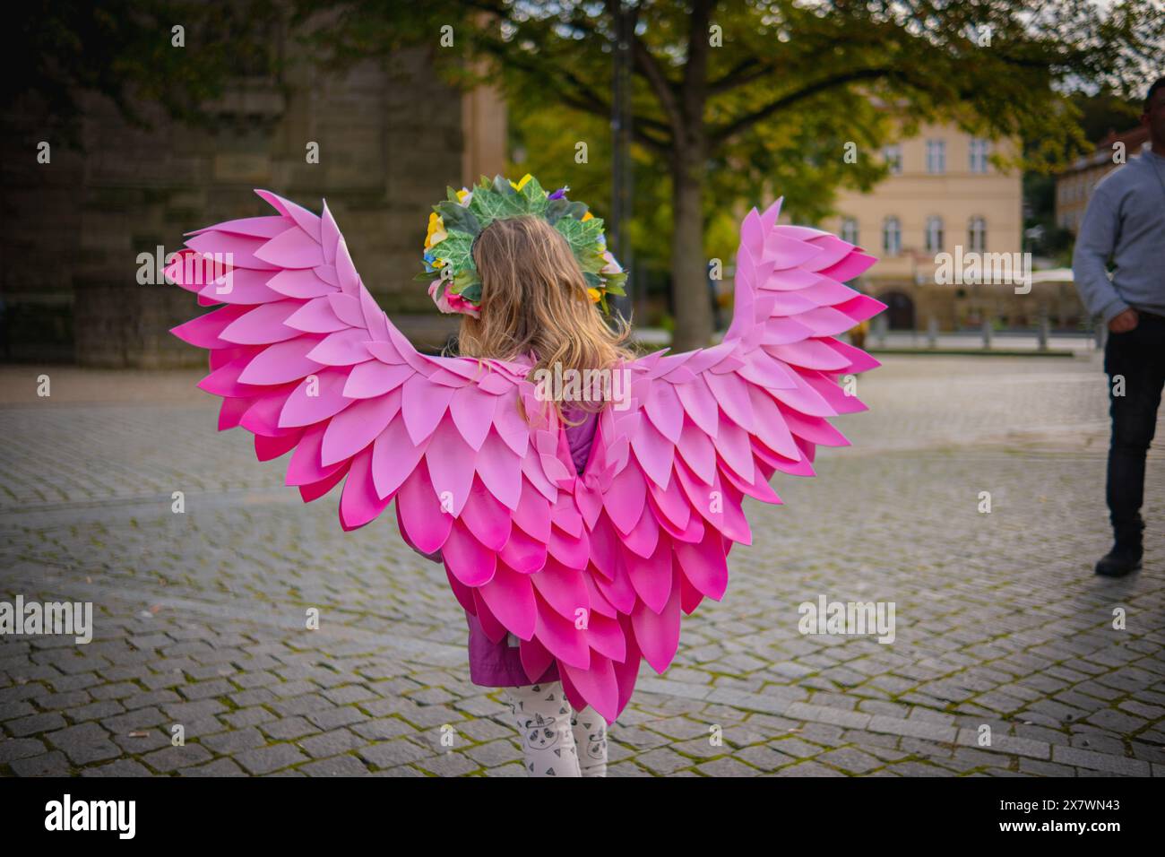 Beautiful young girl wearing pink angel wings. Little cute girl in pink ...