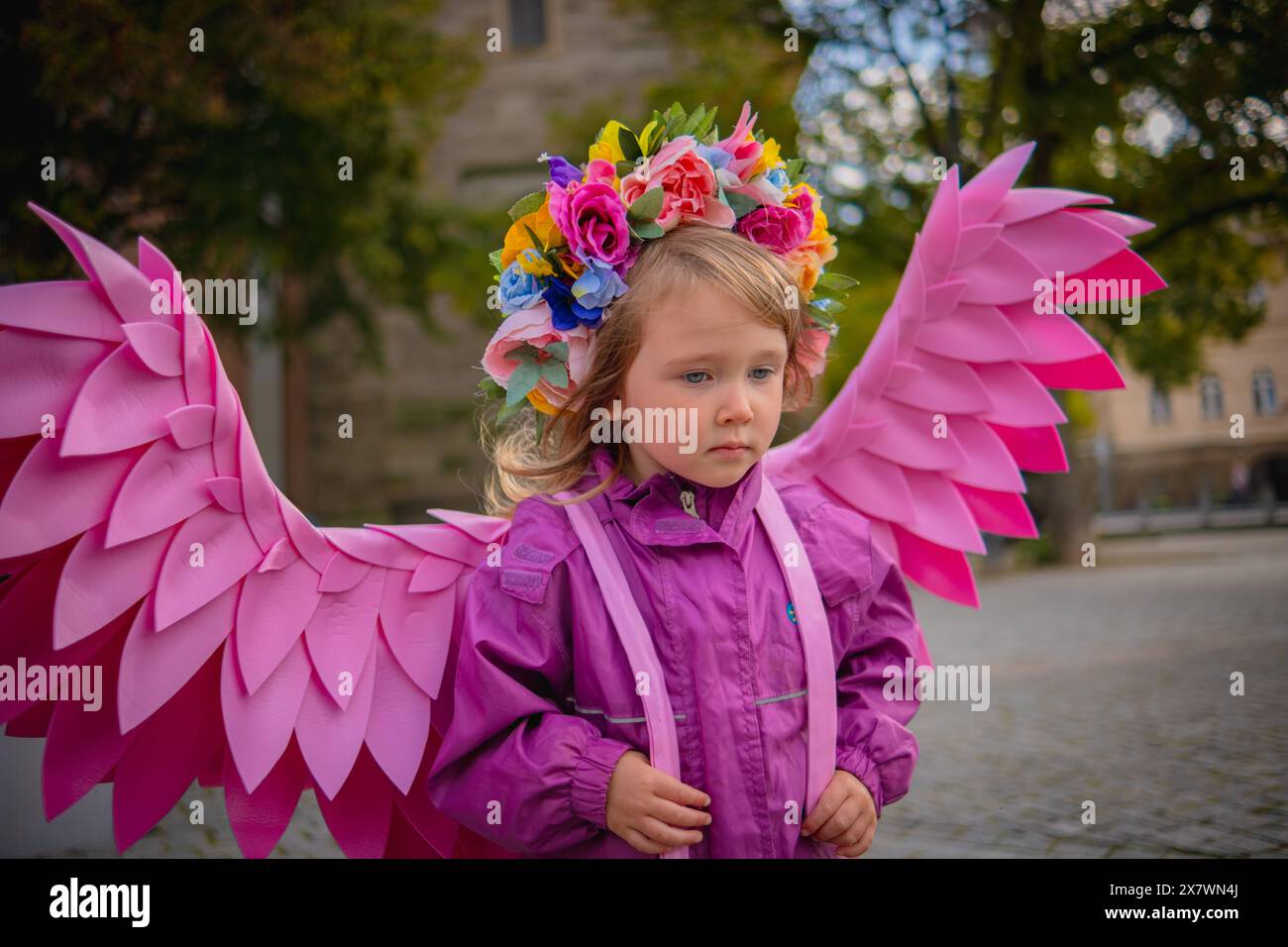 Beautiful young girl wearing pink angel wings. Little cute girl in pink ...