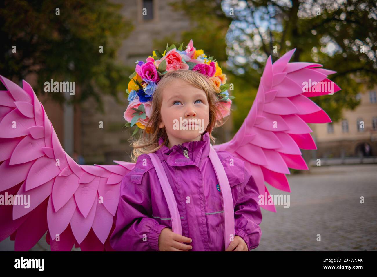 Beautiful young girl wearing pink angel wings. Little cute girl in pink ...