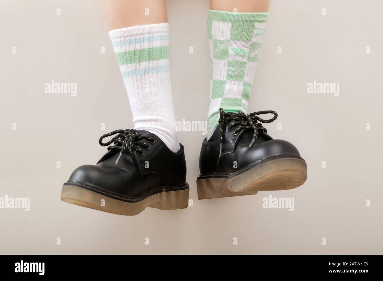 Kid wears different pair of socks. Child foots in mismatched socks ...