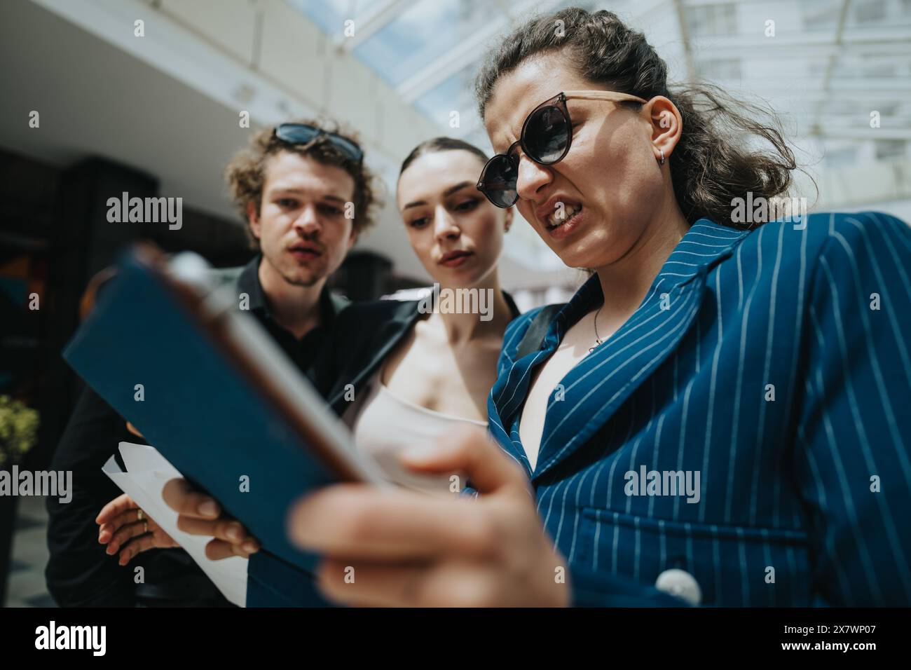 Group of three people discussing intense business meeting in modern ...