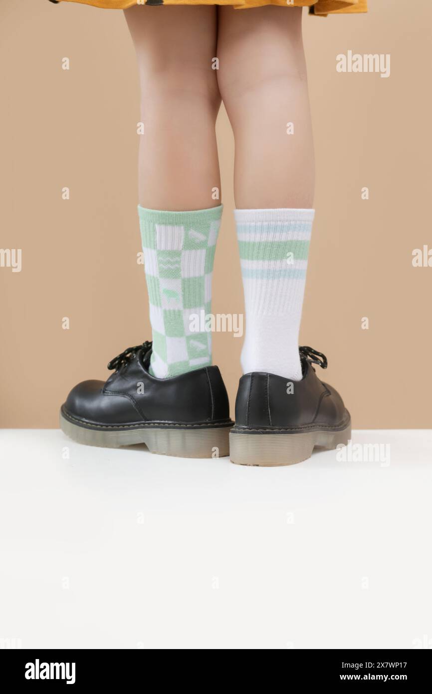 Kid wears different pair of socks. Child foots in mismatched socks ...