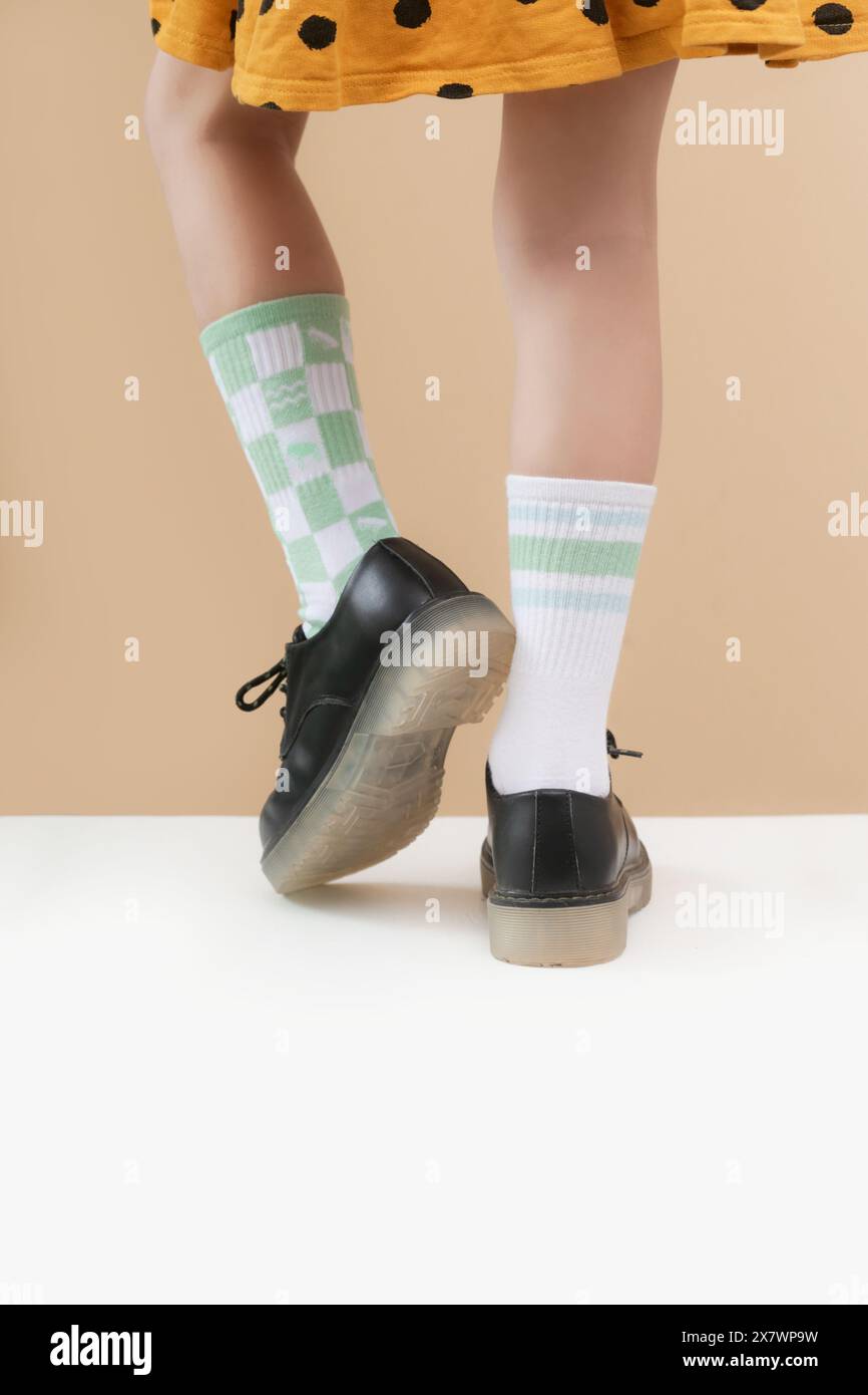 Kid wears different pair of socks. Child foots in mismatched socks ...