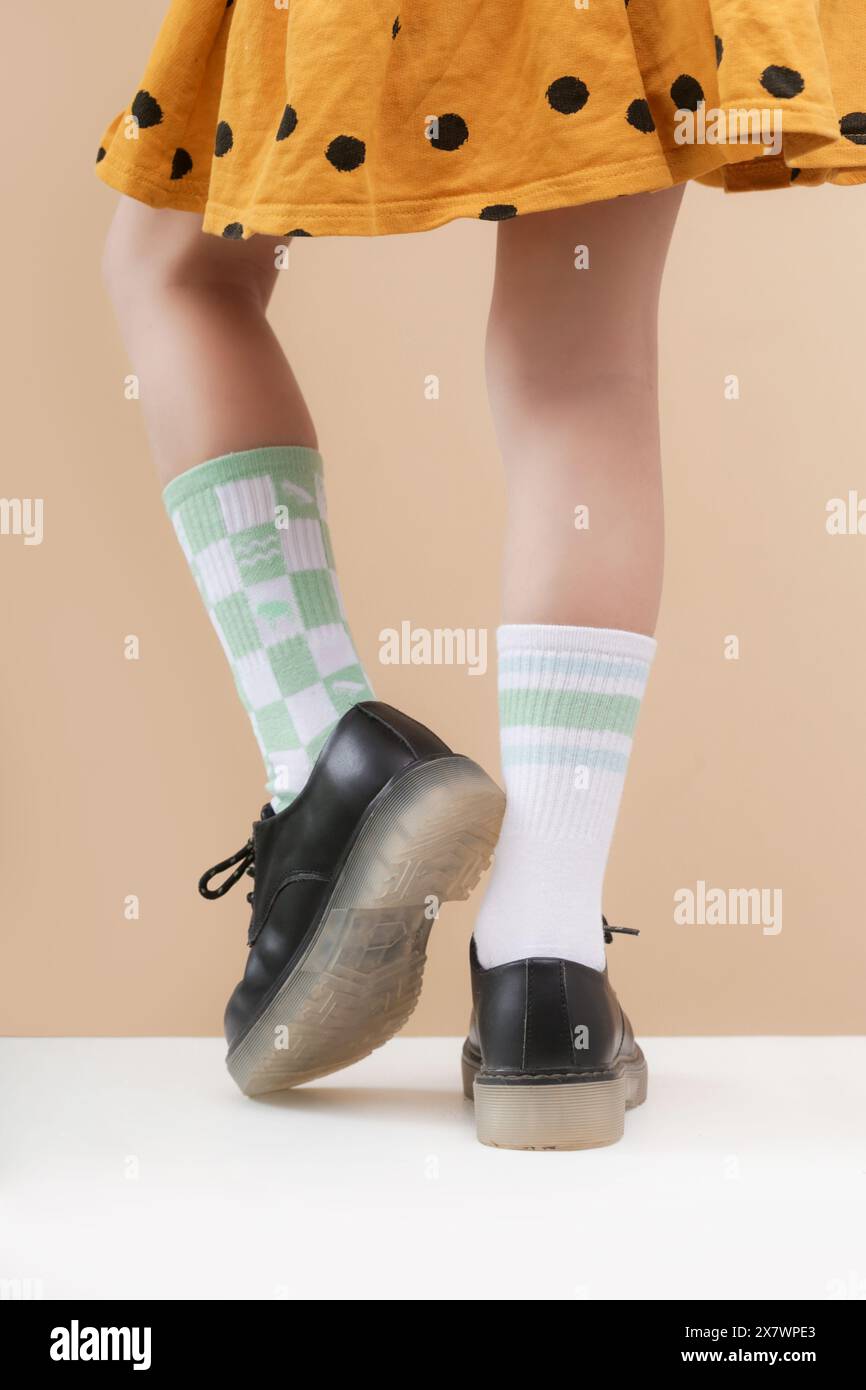 Kid wears different pair of socks. Child foots in mismatched socks ...