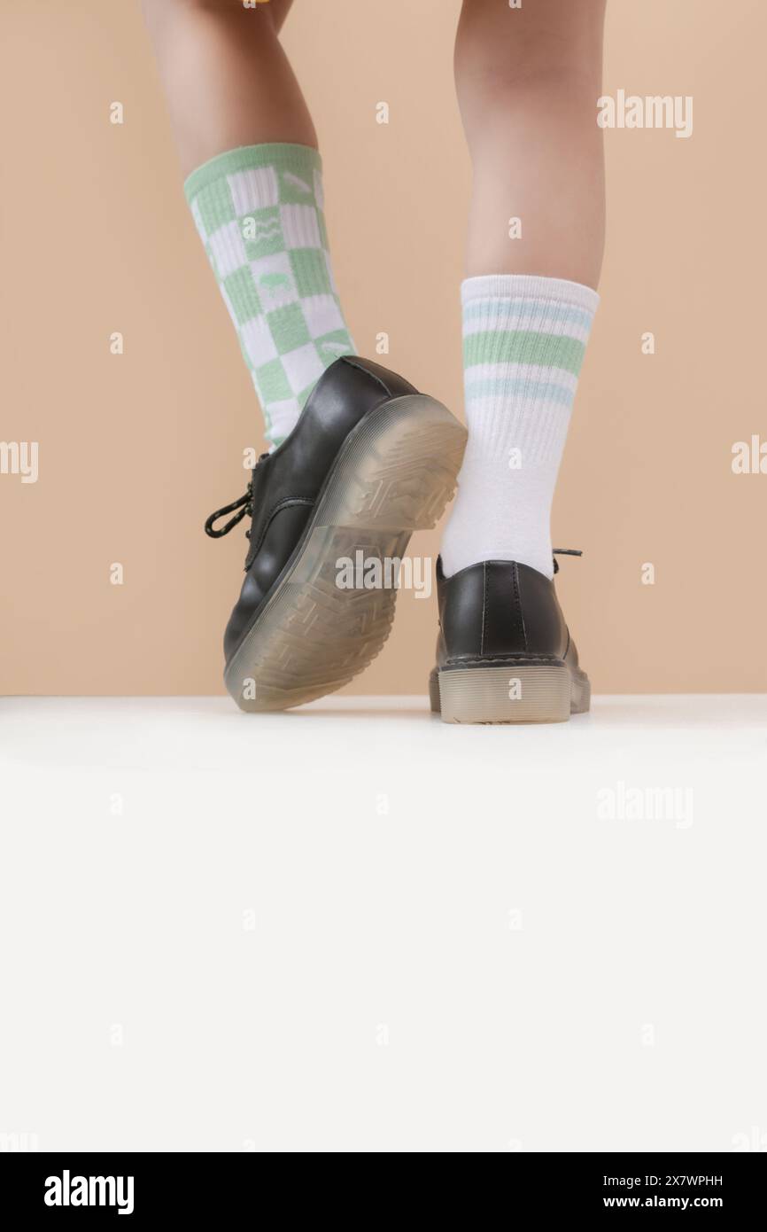 Kid wears different pair of socks. Child foots in mismatched socks ...