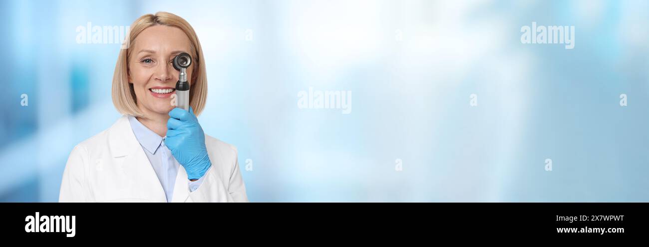 Professional dermatologist with dermatoscope on blurred background ...