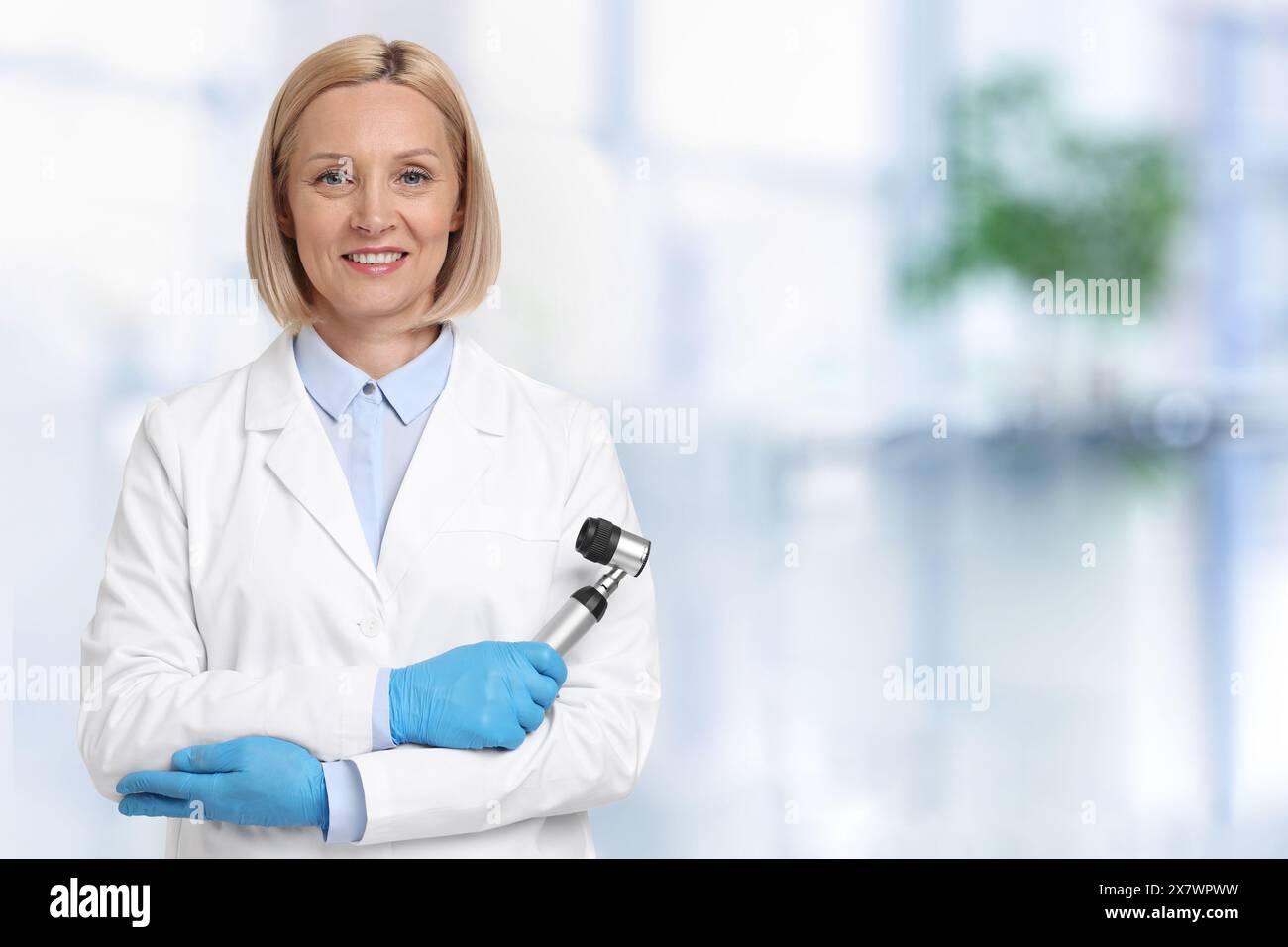 Professional dermatologist with dermatoscope on blurred background ...