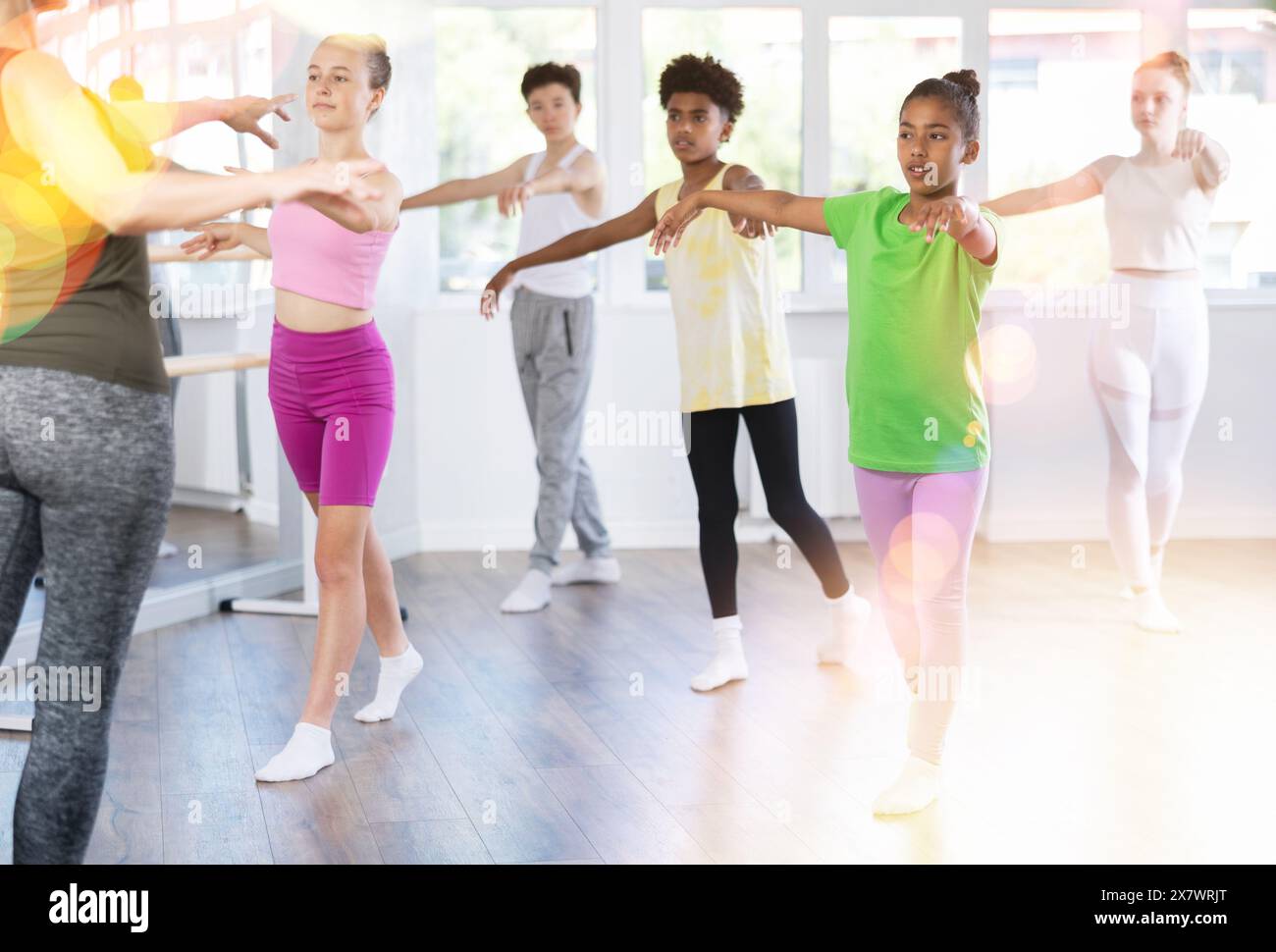 African american teen girl participating in beginner group ballet class ...