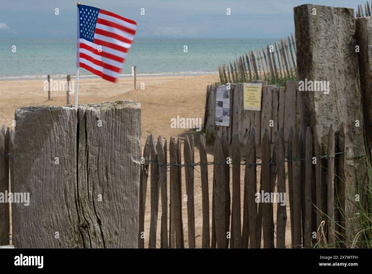 Utah Beach in Normandy, France. Mid range view USA flag on wood sea ...
