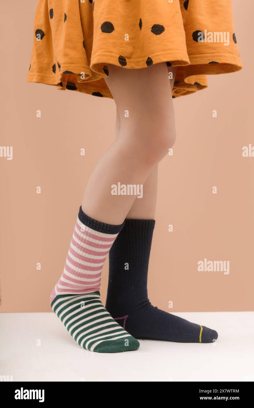 Kid wears different pair of socks. Child foots in mismatched socks ...
