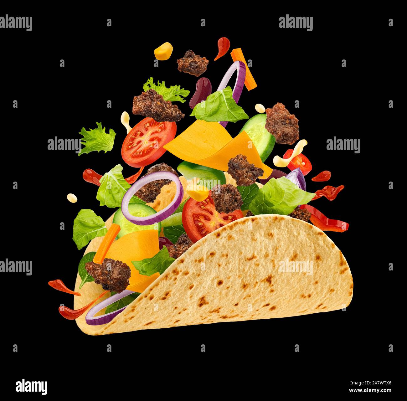 Mexican taco with falling beef meat and vegetables isolated on black ...