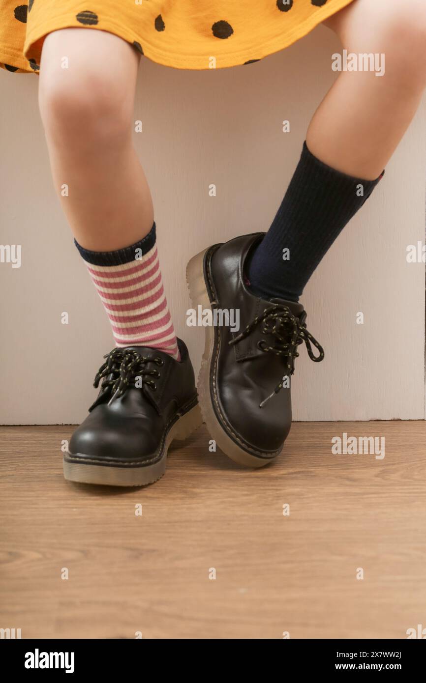 Kid wears different pair of socks. Child foots in mismatched socks ...