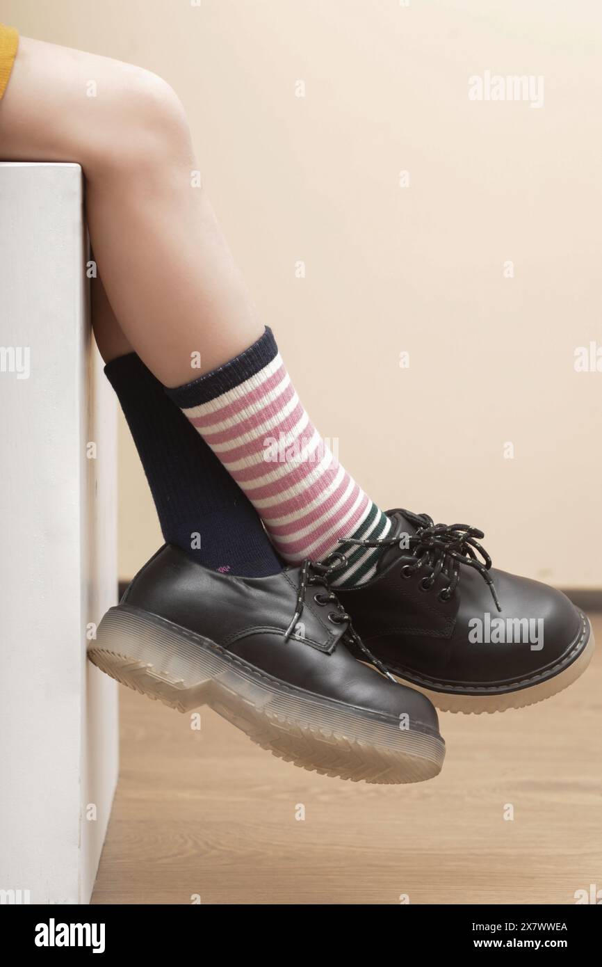 Kid wears different pair of socks. Child foots in mismatched socks ...