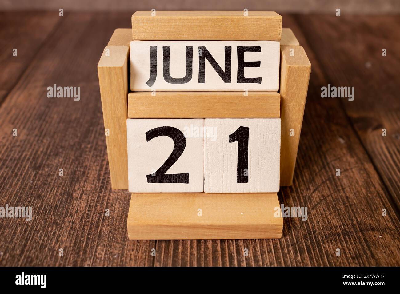 June 21 calendar date text on wooden blocks with blurred nature ...