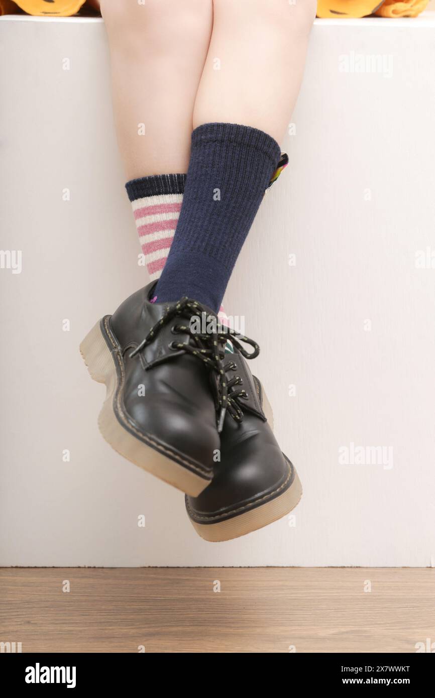 Kid wears different pair of socks. Child foots in mismatched socks ...