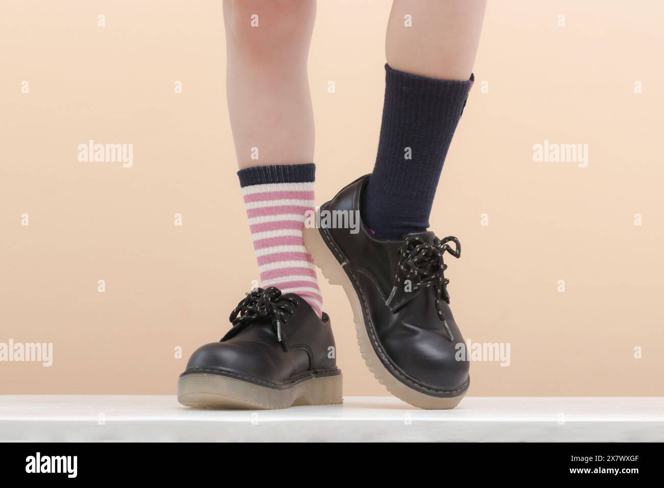 Kid wears different pair of socks. Child foots in mismatched socks ...