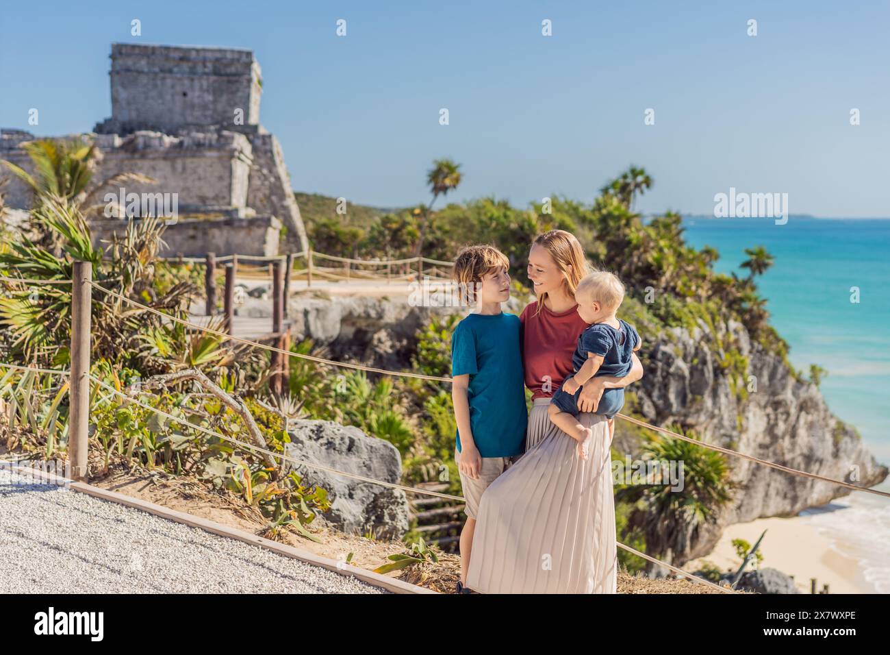 Mother and two sons tourists enjoying the view Pre-Columbian Mayan ...