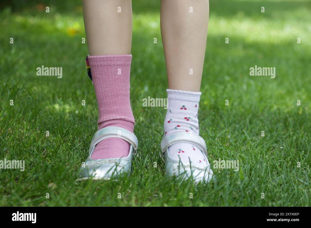 Kid wears different pair of socks. Child foots in mismatched socks ...