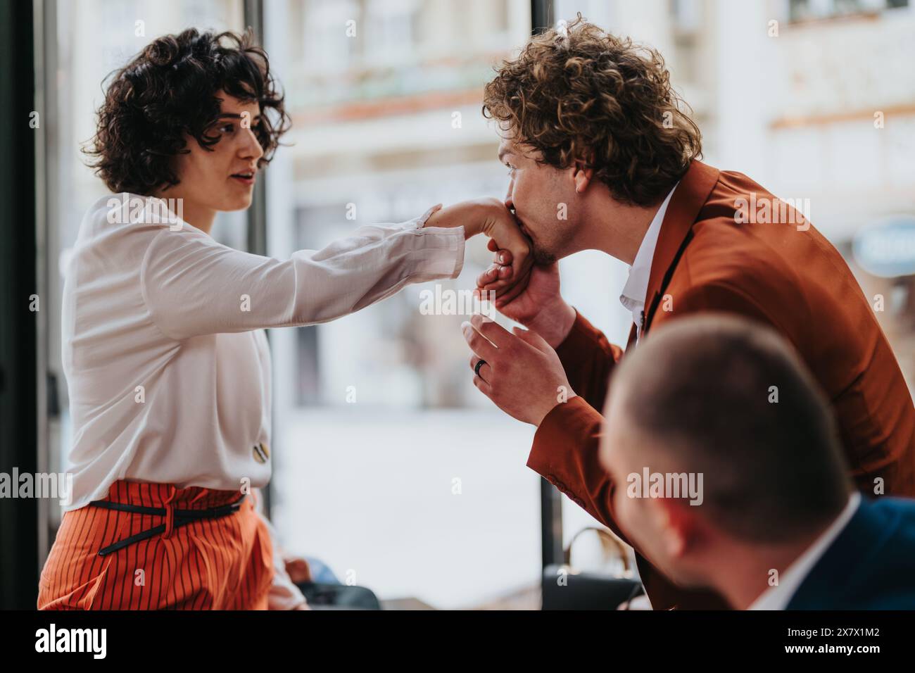 Business colleagues greeting in casual office setting with handshake ...