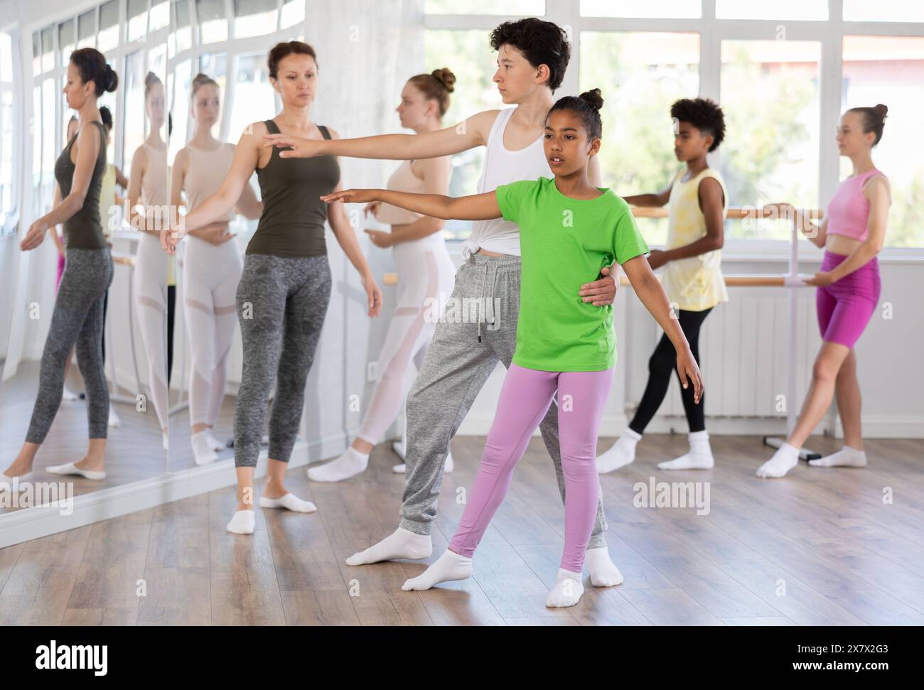 African American teenage girl practicing ballet moves with boy Stock ...