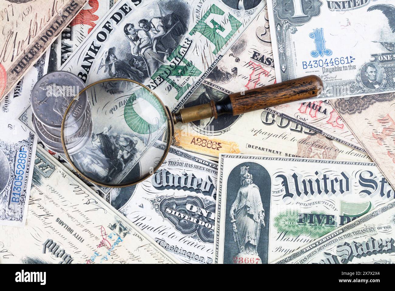 Old US banknotes and silver certificates with silver dollar coins and ...