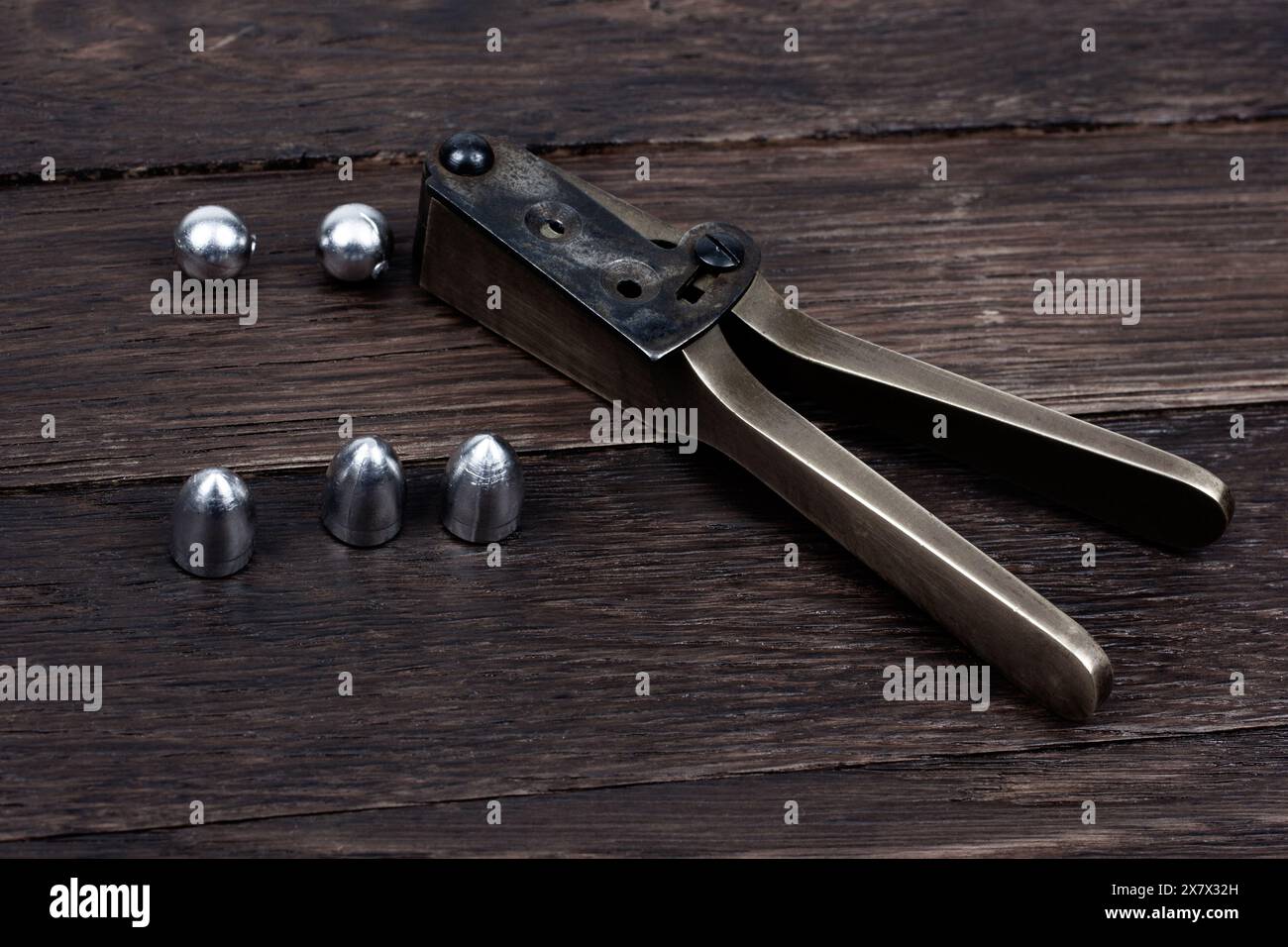 old west bullet mold with bullets for revolver. Isolated on white ...