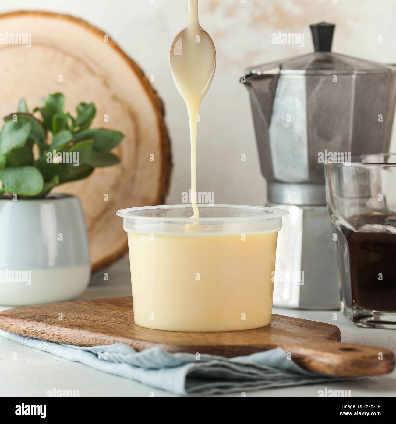 Condensed milk pouring from a spoon, perfect for desserts and ...